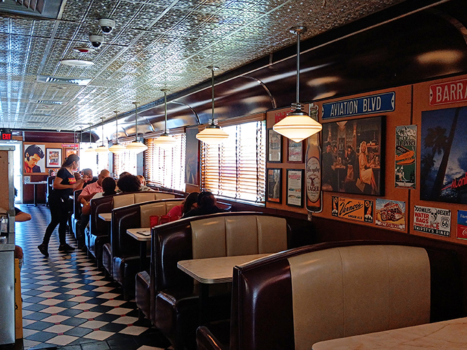 Booths designed for comfort and conversation. The vintage posters aren't just decoration—they're silent witnesses to countless first dates and family celebrations.