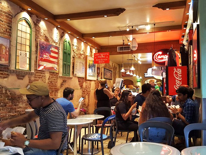 The universal language of sandwich enjoyment, spoken fluently by everyone who walks through Campo's doors. Notice the focused expressions of culinary contentment.