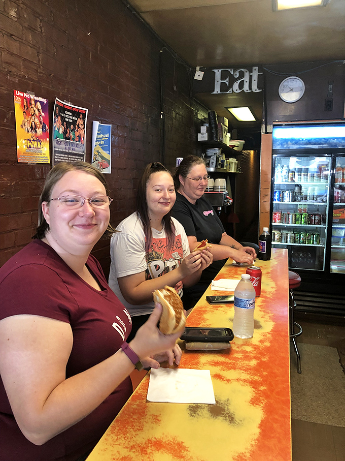 These aren't just customers—they're members of a delicious secret society. The smiles say everything words can't about Squeeze-In satisfaction.