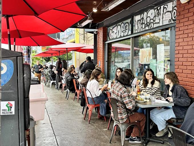 The red umbrellas create an outdoor sanctuary where Angelenos commune over the universal religion of good breakfast and better coffee.