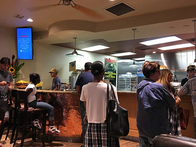 The copper counter gleams with promise as hungry patrons line up for their crispy fix.