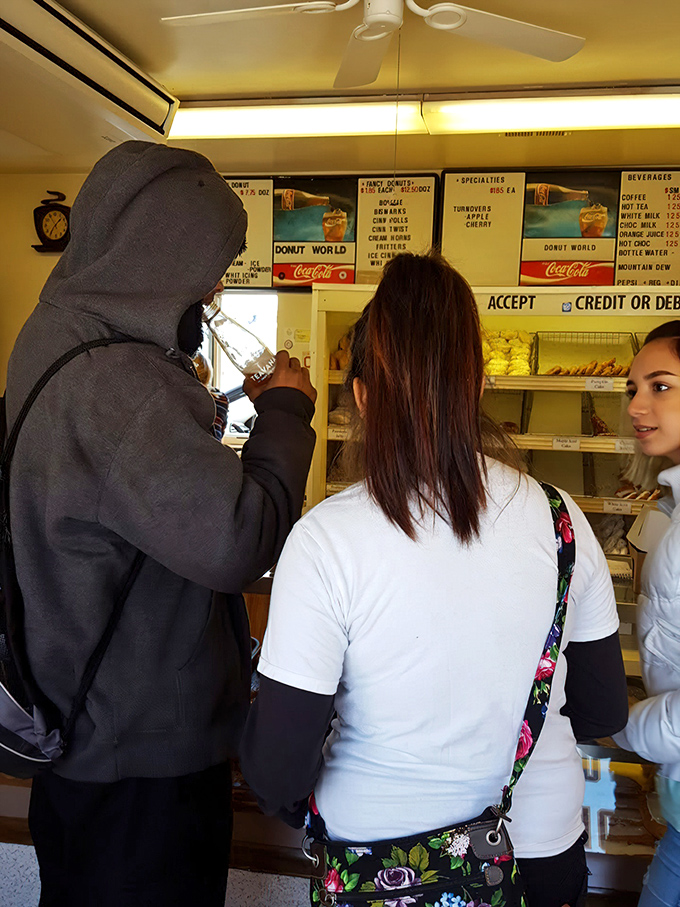 The universal language of donut anticipation brings people together. That moment before the first bite is pure, shared human experience.