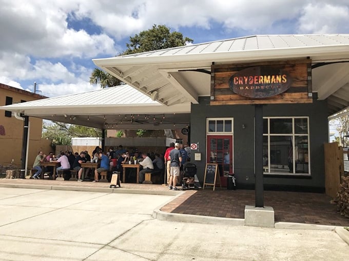 Sun-drenched outdoor dining where strangers become friends, united by the universal language of exceptional barbecue.