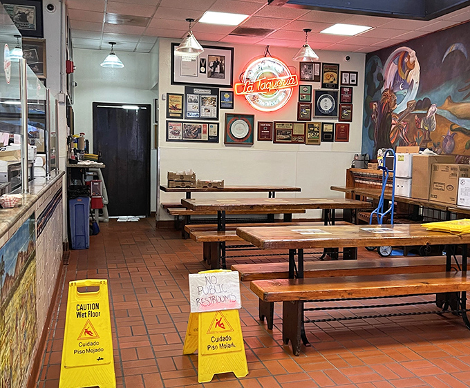 Even empty, the dining room hums with anticipation. Those neon signs and framed accolades aren't just decoration—they're trophies of taste.