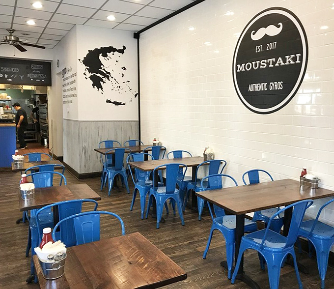 The silhouette of Greece adorning the wall reminds you this isn't just dinner—it's a culinary passport to the Mediterranean.