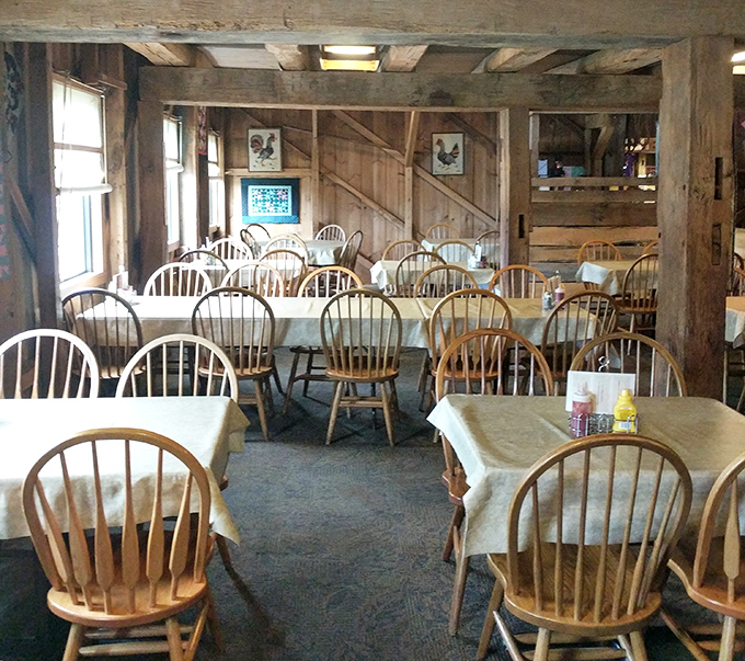 Windsor chairs and white tablecloths create dining spaces that feel both spacious and intimate, like eating in your wealthy farmer uncle's dining room.