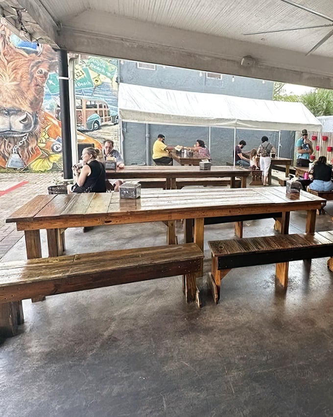 The dining area where time slows down and conversations flow as freely as the sweet tea. Note the lion mural standing guard.
