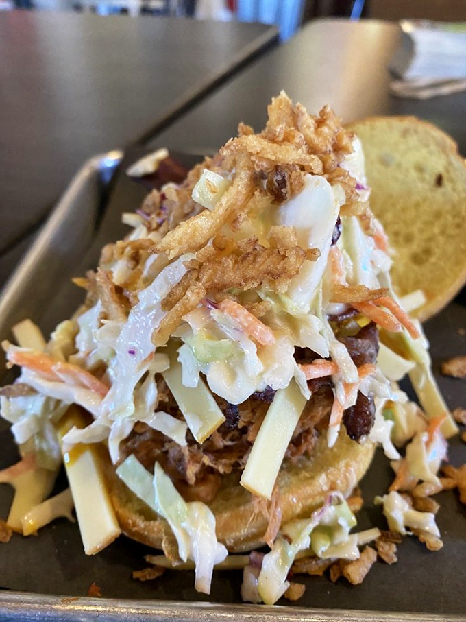 The Florida Cracker sandwich stands tall and proud, a towering monument to coleslaw engineering and pulled pork perfection.