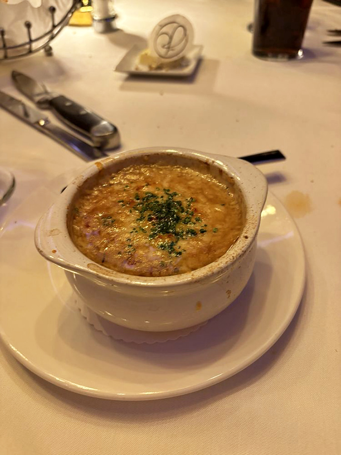 French onion soup with a cheese cap so perfect it deserves its own Instagram account. Comfort food with a tuxedo on.