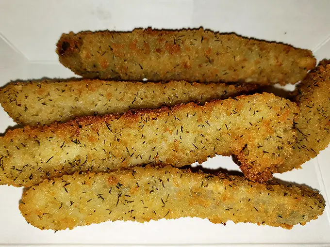 Fried pickles with just the right amount of herby breading—crunchy, tangy perfection that disappears from the basket with suspicious speed.