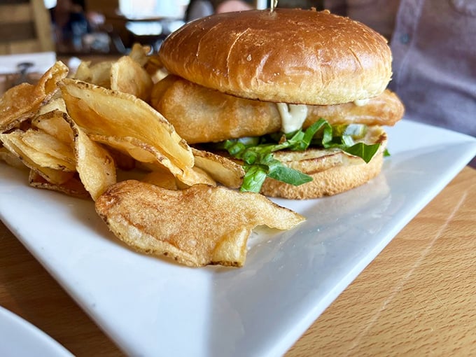 A fish sandwich that doesn't hide behind excessive toppings—just honest-to-goodness seafood on a bun with house-made chips that shatter satisfyingly.
