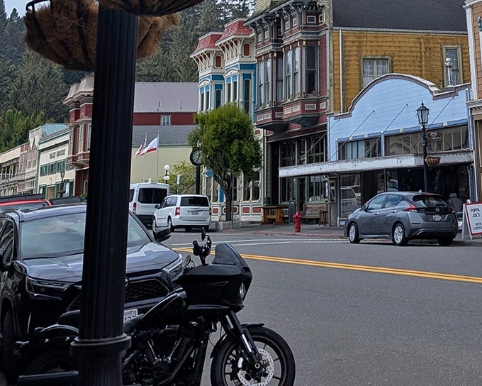 Main Street after dark transforms into a glowing gallery of Victorian silhouettes—Edward Hopper meets Disneyland's Main Street, minus the crowds.