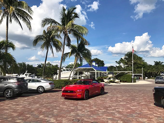 Gramma Dot's Restaurant: Palm trees, boats, and a red Mustang—just another day in paradise. Island living where the transportation is as stylish as the setting.