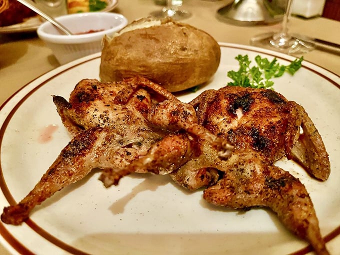 Quail that's been kissed by oak smoke and blessed with seasonings. That baked potato stands by, ready for its supporting role.