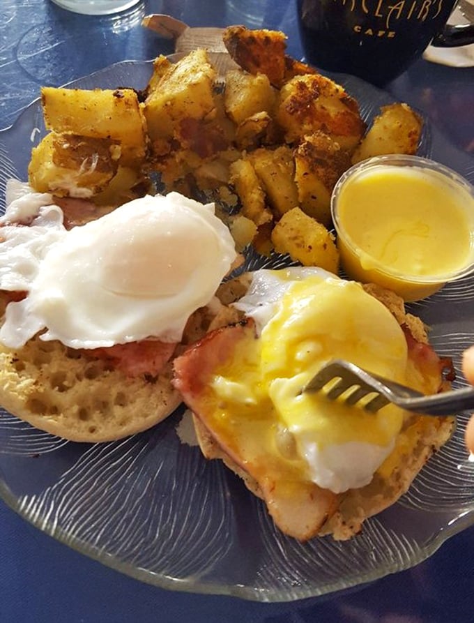 Eggs Benedict that makes you want to write poetry—perfectly poached eggs performing a synchronized swimming routine in hollandaise with home fries as the cheering section.