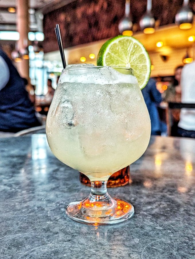 This isn't just a cocktail—it's liquid vacation in a glass. The lime perched on the rim is practically winking at you.