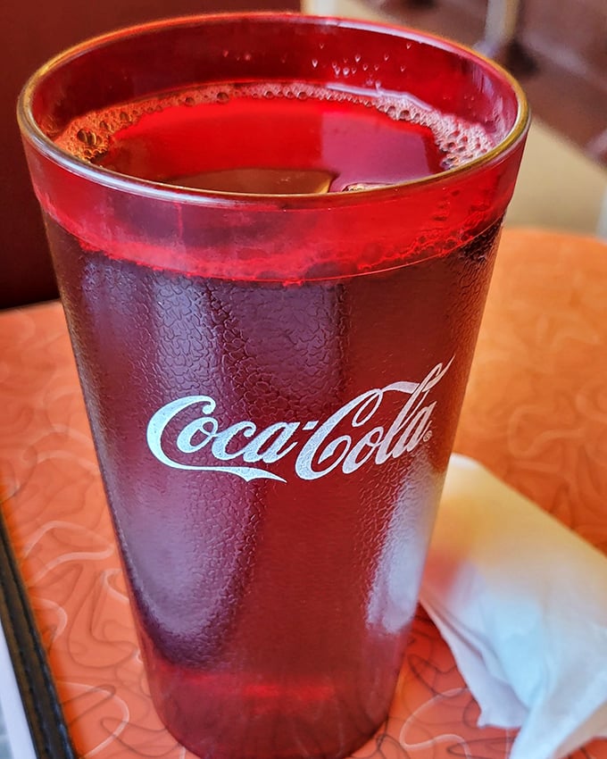 A classic Coca-Cola in a retro glass – sometimes the simplest pleasures are the most satisfying. Condensation beads promise refreshment.