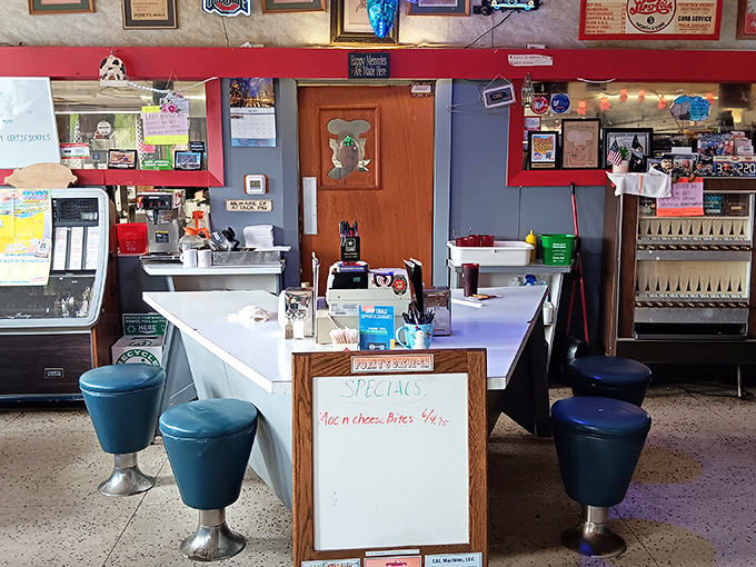 The counter view reveals the heart of Porky's operation—where handwritten specials and decades of service have created a genuine small-town institution.