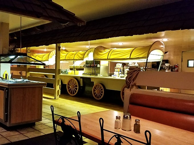 The covered wagon salad bar is peak Americana steakhouse design—where form follows function and nostalgia comes standard with every meal.