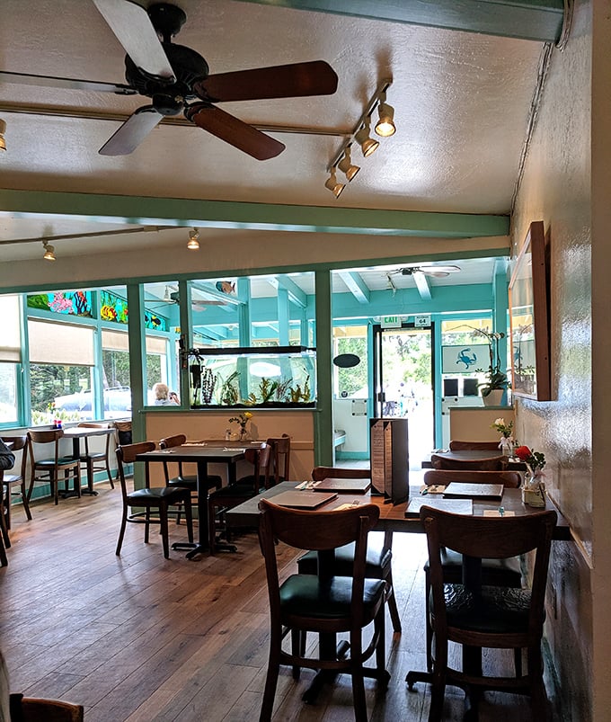 Aqua walls and natural wood create a space that feels like the inside of a particularly stylish fishing boat. Minus the seasickness.