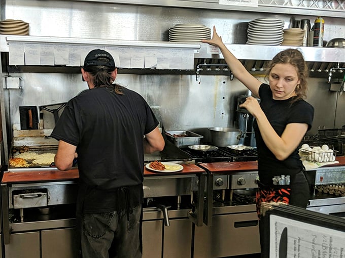 Where breakfast dreams come true—the open kitchen at Wynn's. No fancy techniques, just skilled hands creating morning masterpieces with practiced efficiency.