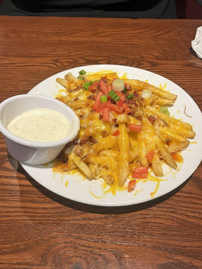 Loaded fries that require a strategy to eat—each bite a tactical decision balancing cheese pull, bacon bits, and the perfect amount of dipping sauce.