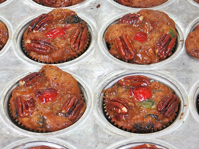Mini pecan pies topped with cherries and nuts—proof that sometimes the best things come in small, sticky packages.