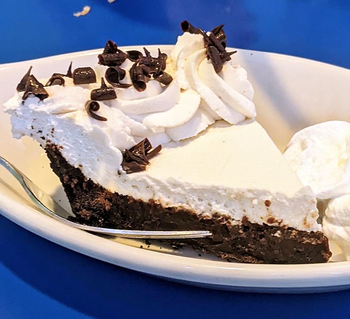 This isn't just pie – it's a chocolate-whipped cream skyscraper of joy that makes calorie-counting seem like the silliest concept ever invented.