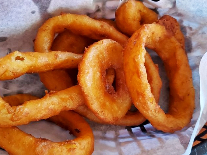 These onion rings aren't just side dishes—they're golden halos of happiness that make you question why anyone would ever choose fries instead.