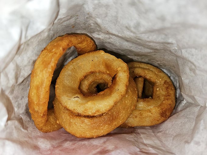 These aren't just onion rings—they're golden halos of happiness that crunch loud enough to drown out your diet's complaints.