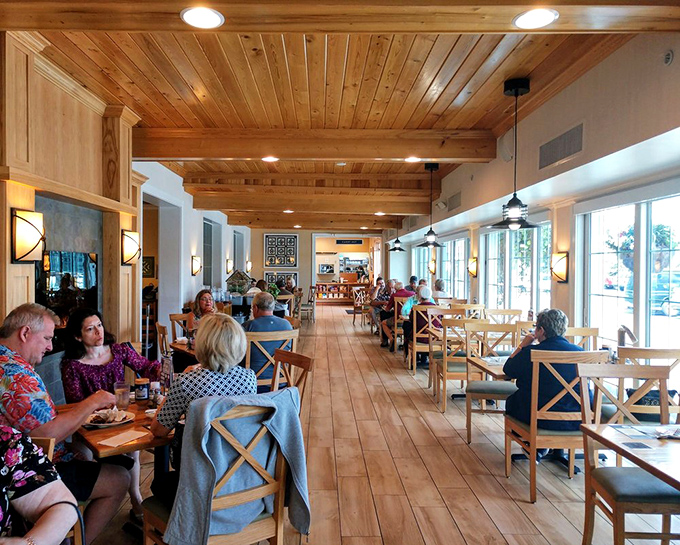 Warm wood tones and natural light create an atmosphere where conversations flow as easily as the coffee—comfort food deserves comfortable surroundings.