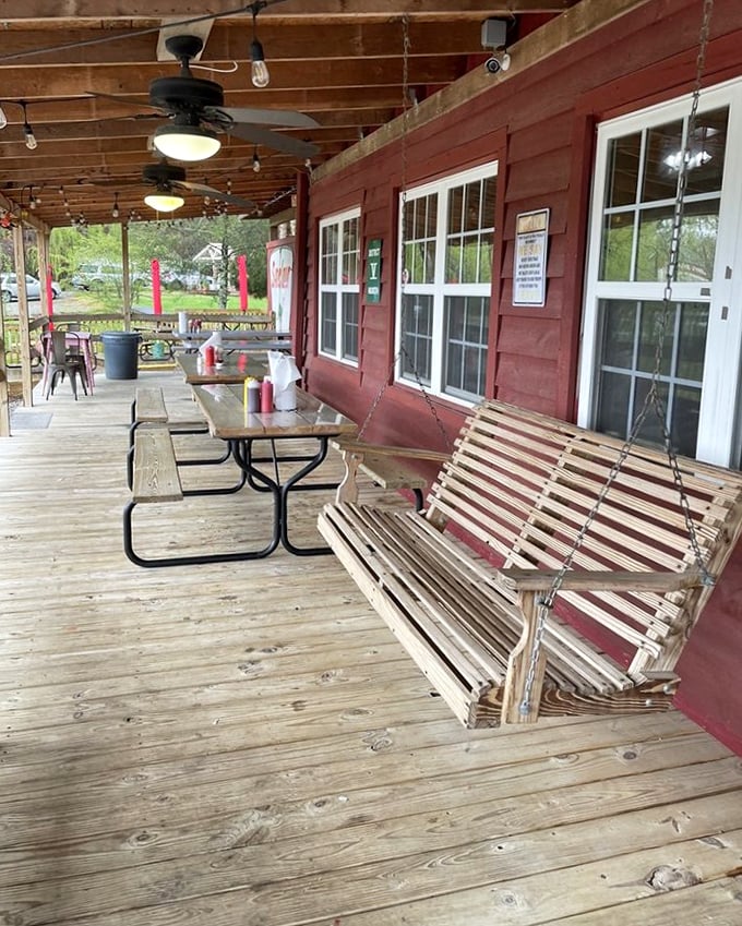 That porch swing isn't just seating—it's an invitation to slow down. The perfect spot to contemplate life's big questions, like "Should I order seconds?"