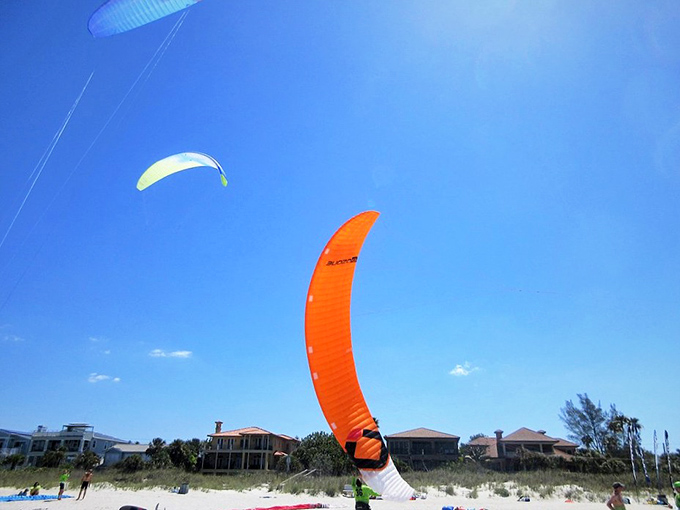 Kiteboarding against an impossibly blue sky. Some visitors prefer adrenaline with their vitamin D—Florida's version of extreme sports!