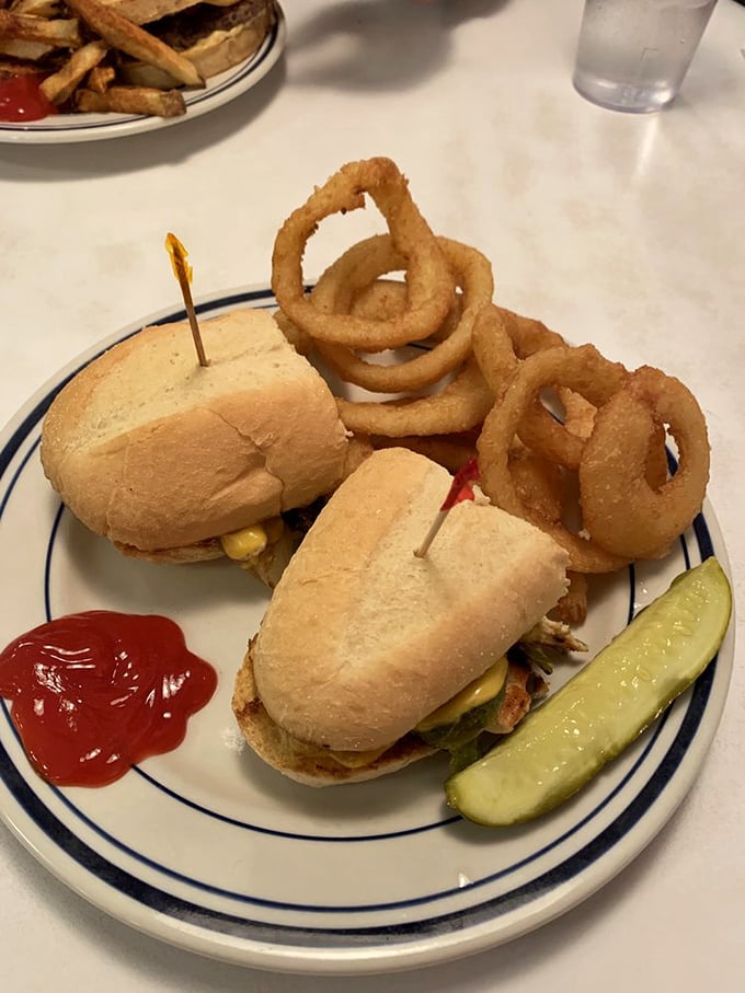 Sliders and onion rings that don't just satisfy hunger—they abolish it, with a pickle spear standing guard to cut through all that delicious richness.