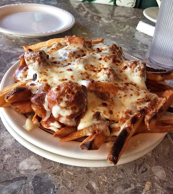 French-Canadian poutine meets Polish hospitality—crispy fries buried under an avalanche of melted cheese and magic. Diet plans surrender at the table.