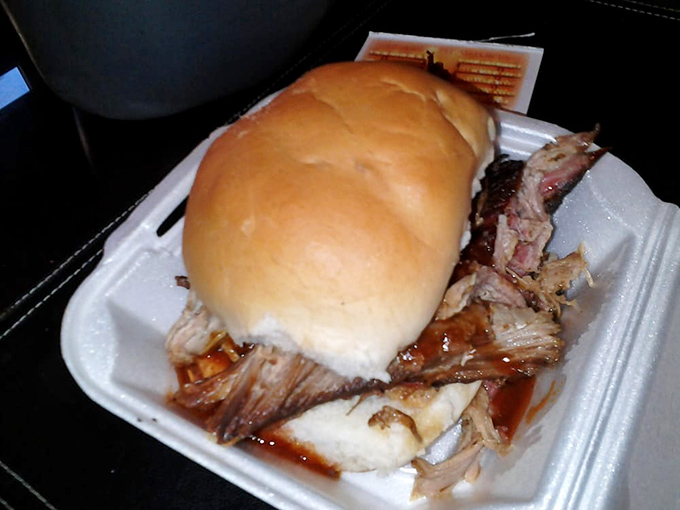 A pulled pork sandwich so generous it's trying to escape its container. This isn't lunch; it's an edible adventure.
