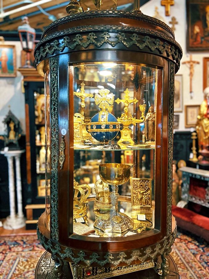 This ornate display case doesn't just hold religious artifacts—it cradles centuries of devotion behind glass, each golden item telling its own sacred story.