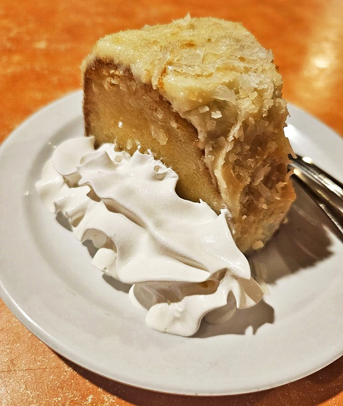 The coconut rum cake—where tropical flavors and comfort desserts collide in a sweet finale that makes you consider ordering a second slice.