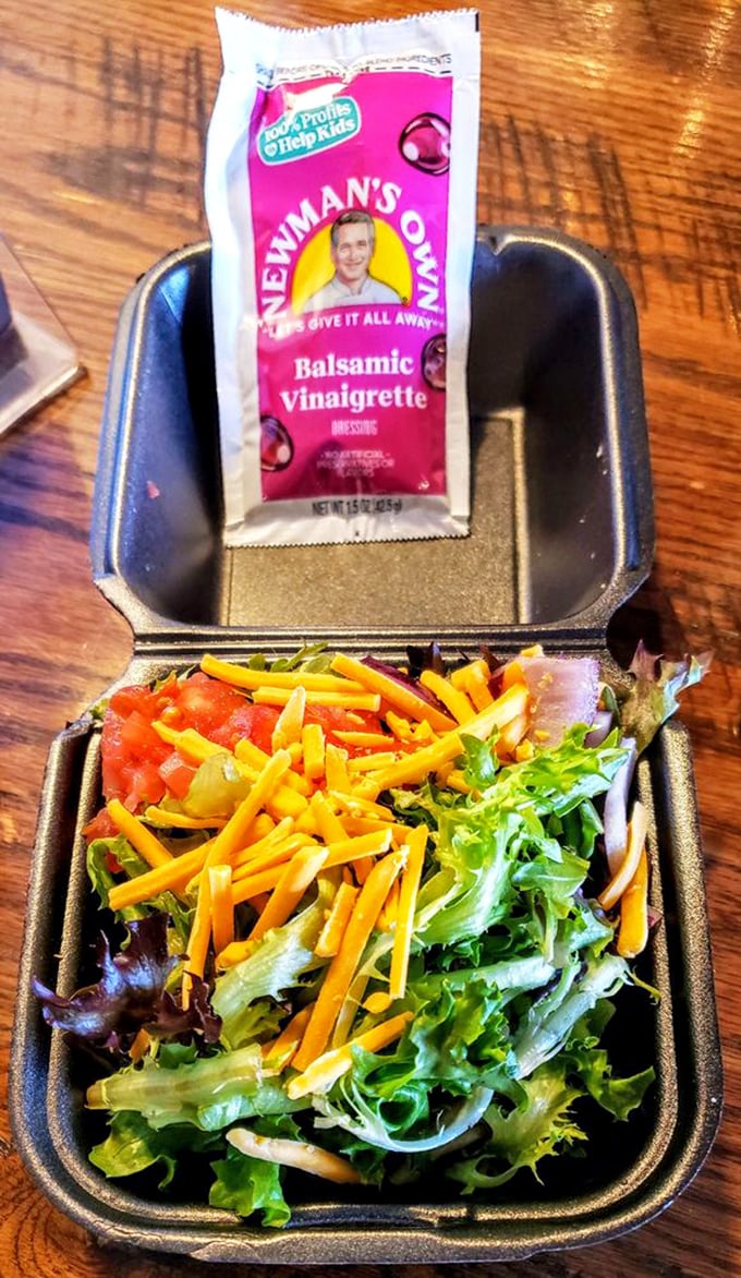 Even the salad looks happy to be here, bright with cheese and fresh greens—the token vegetable that doesn't feel like punishment.