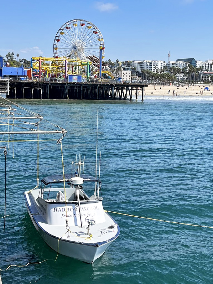 The Harbor Patrol boat stands sentinel in turquoise waters, protecting paradise while most visitors focus only on finding the perfect funnel cake.
