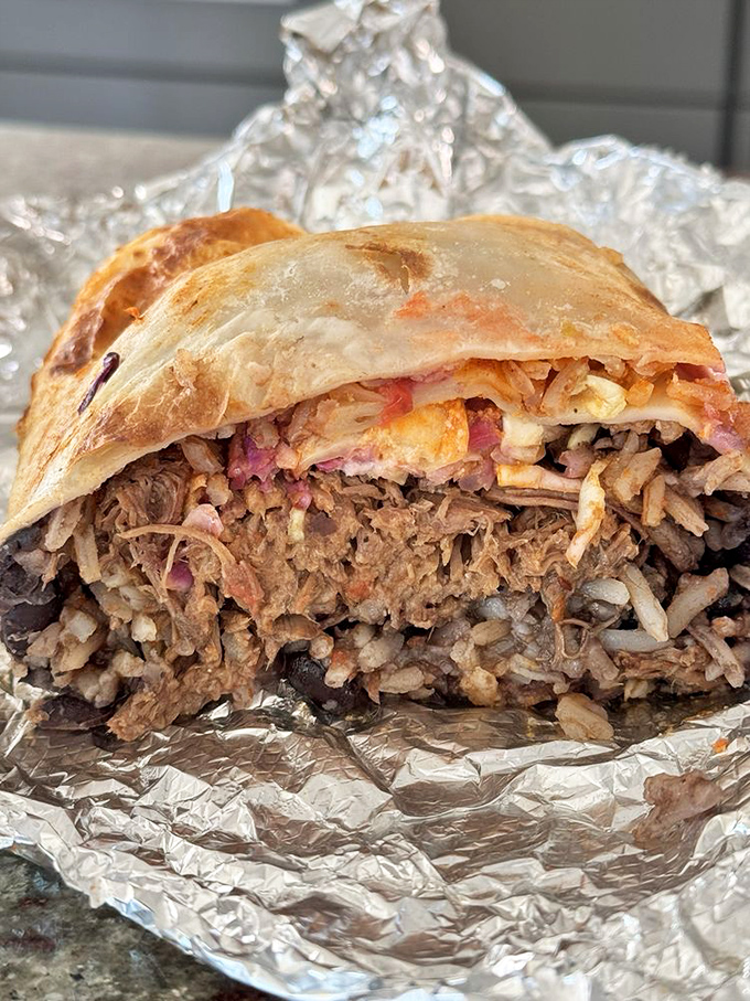 Behold the burrito in its natural habitat—aluminum foil. Cut open to reveal layers of flavor that tell a delicious California story.