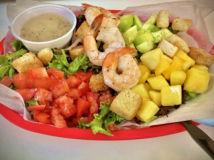 This isn't just a salad—it's Florida sunshine arranged on a plate with plump shrimp standing guard over mango treasures.