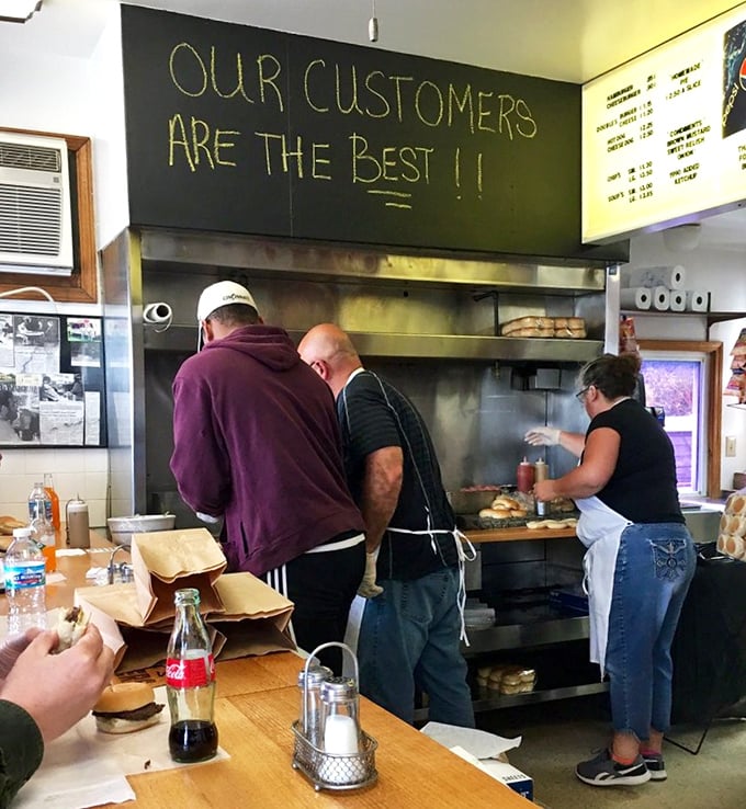 "Our customers are the best!" proclaims the chalkboard, as the staff works their magic on the flat-top grill. Burger theater at its finest.