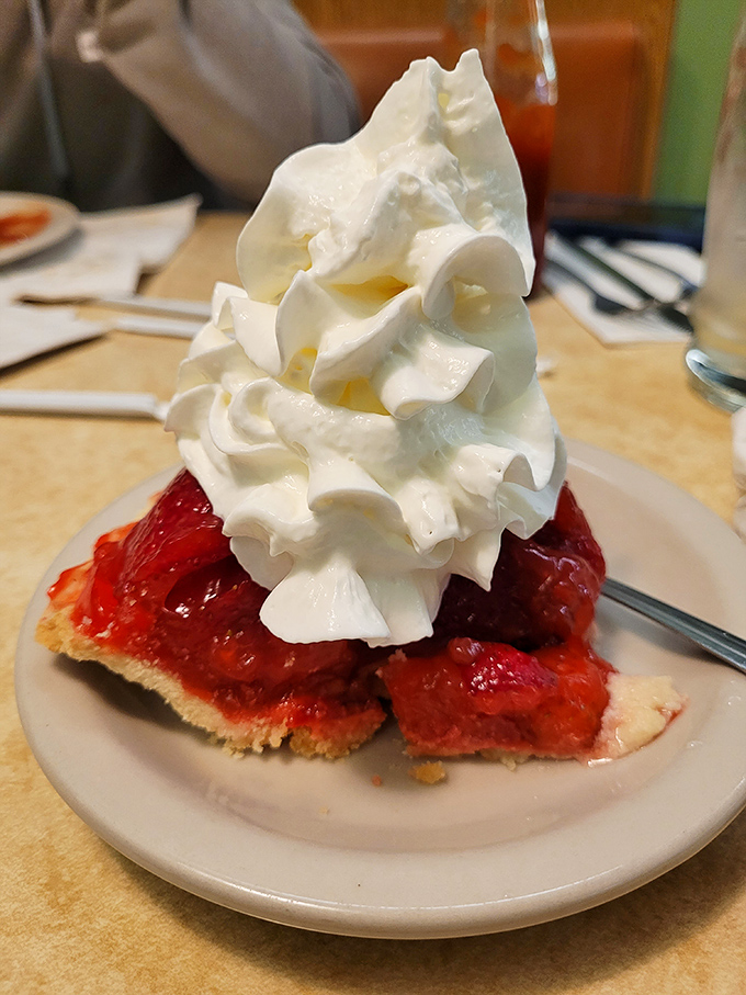 Strawberry pie that doesn't need a fancy pedigree—just fresh berries, flaky crust, and a mountain of whipped cream that means business.