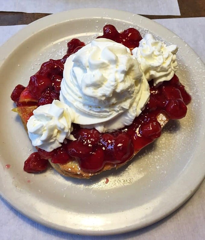 Stuffed French toast crowned with strawberries and whipped cream – breakfast that boldly crosses the line into dessert territory without apology.