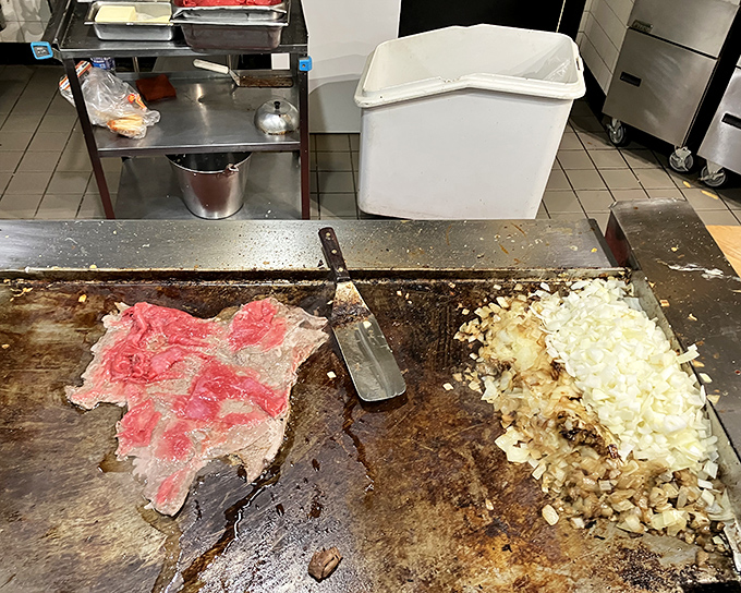 Behind the scenes magic – where thinly sliced ribeye meets the sizzling grill. The start of something beautiful.