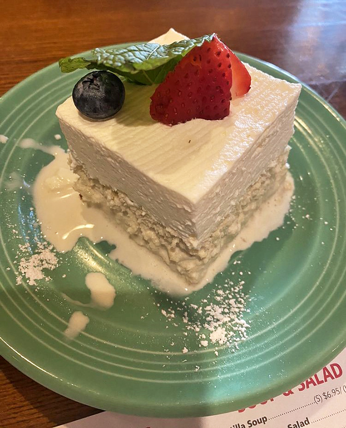 Tres Leches cake that defies gravity – impossibly light despite being soaked in three milks and topped with fresh berries.