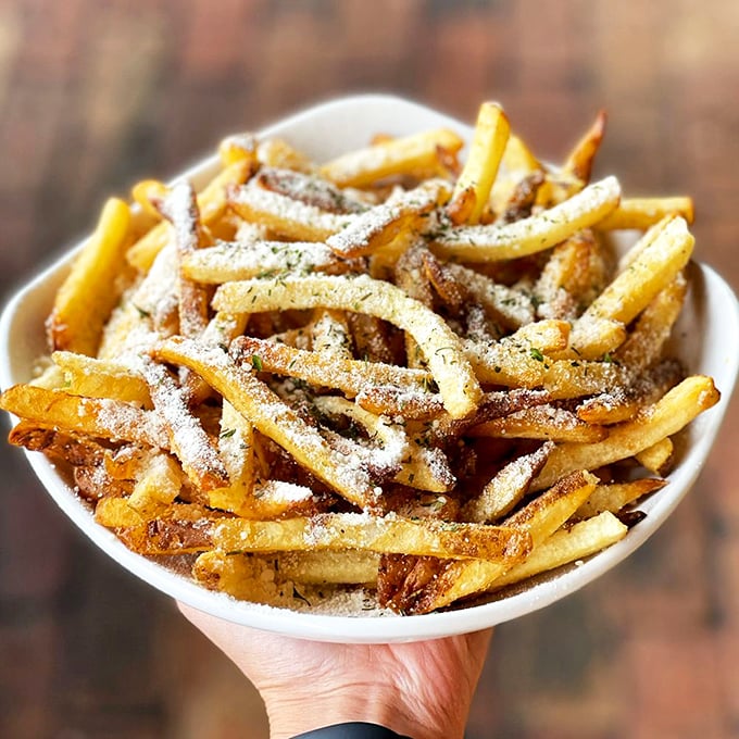 These aren't just fries—they're golden wands of potato perfection dusted with parmesan that make regular fries seem like they're not even trying.