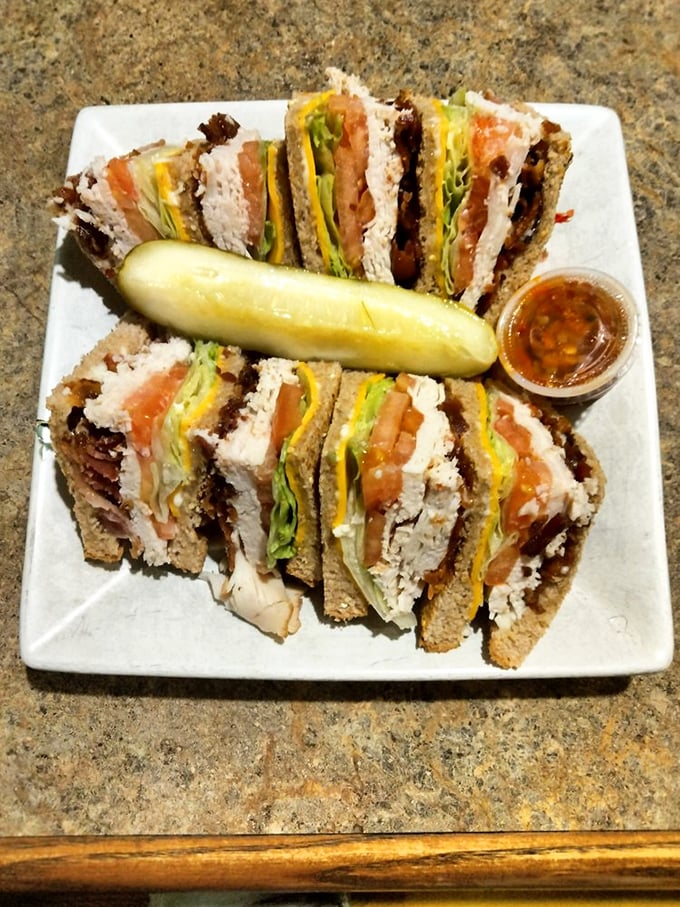 This club sandwich stands taller than most Maryland politicians, layered with turkey, bacon, and fresh veggies—the pickle is just showing off.