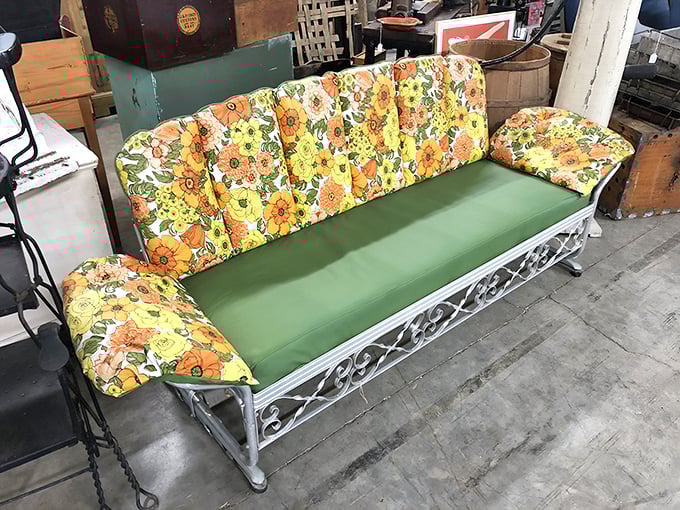 That floral-cushioned glider isn't just outdoor furniture—it's a time machine to summer evenings when neighbors actually talked to each other.
